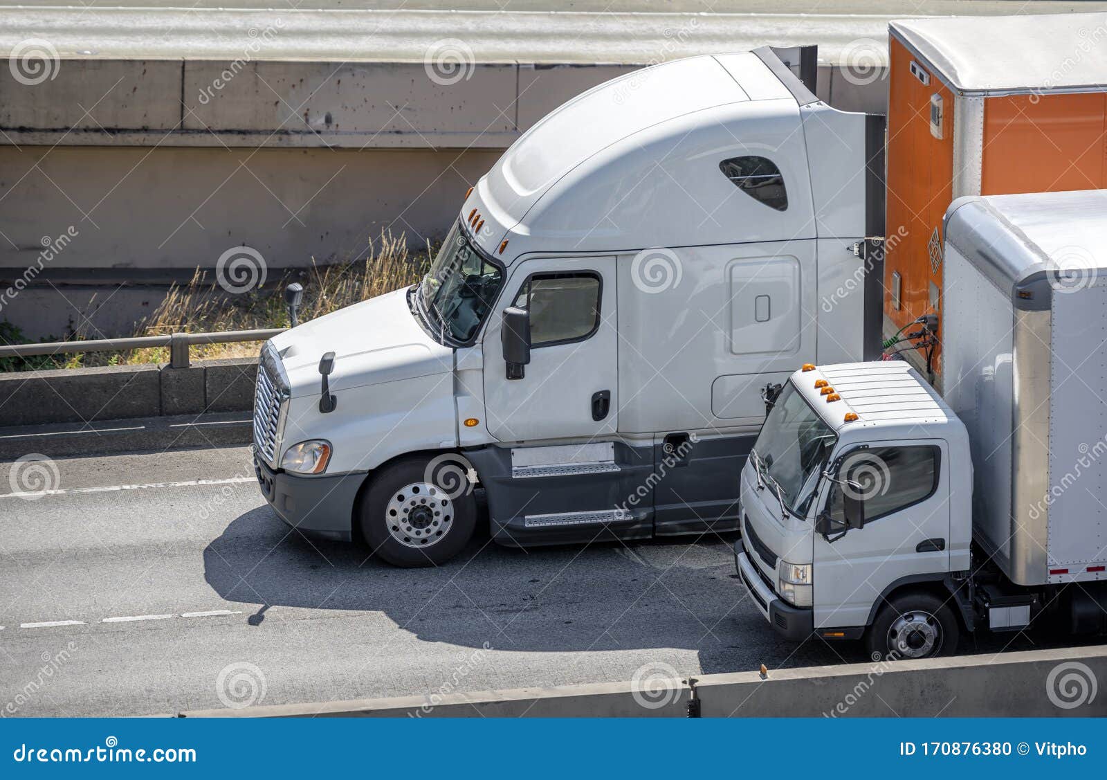 Small Cabover Rig Semi Truck With Box Trailer Loading Cargo Standing In ...