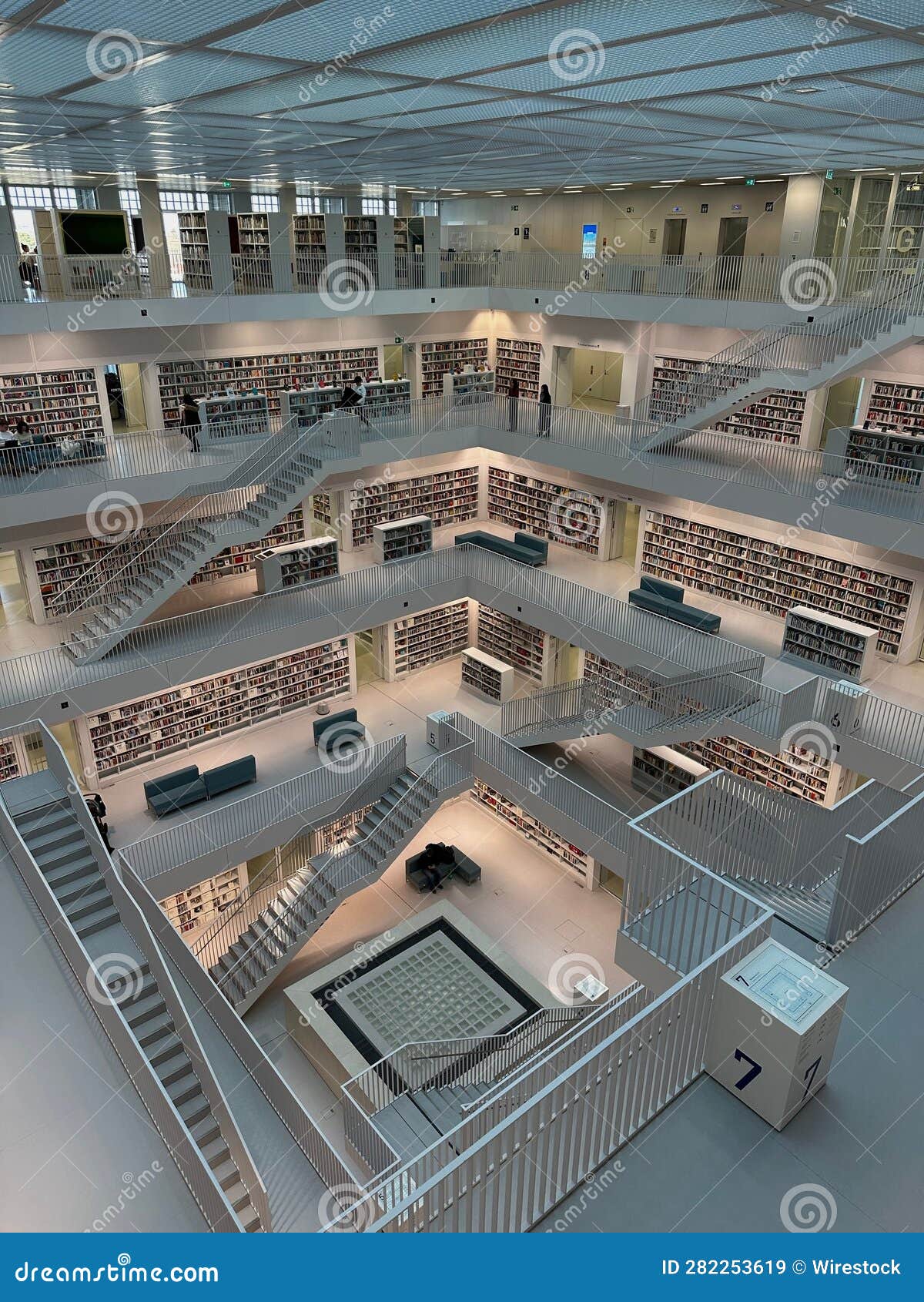 Big Sophisticated Library with Many Books and Several People Walking ...
