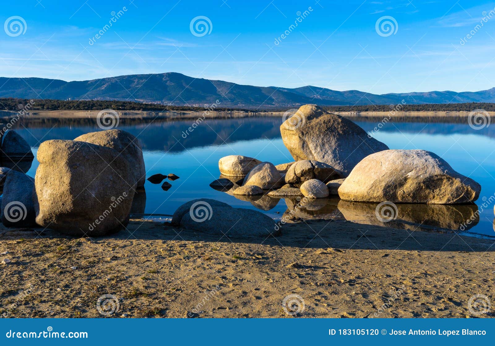 Big Stone or Rock in Lake or See with Mountains in Background Stock ...