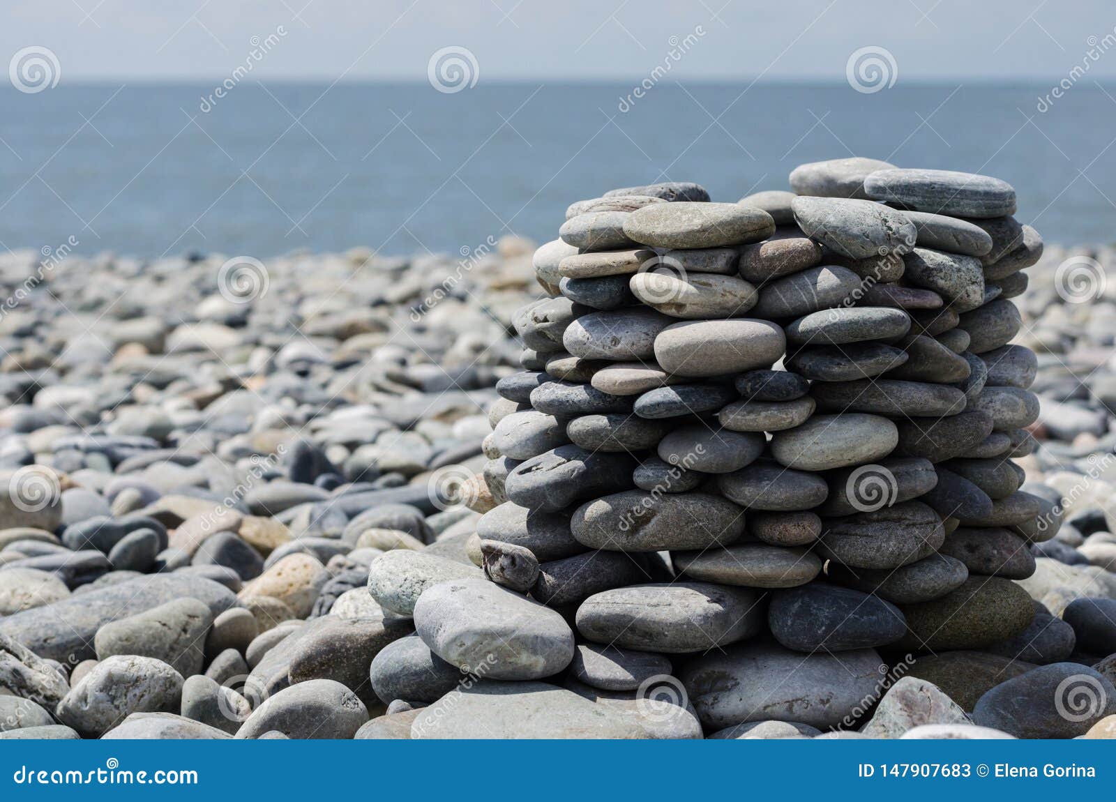 Big Tower of Stones on the Coast of the Sea with Pebbles Stock Image ...