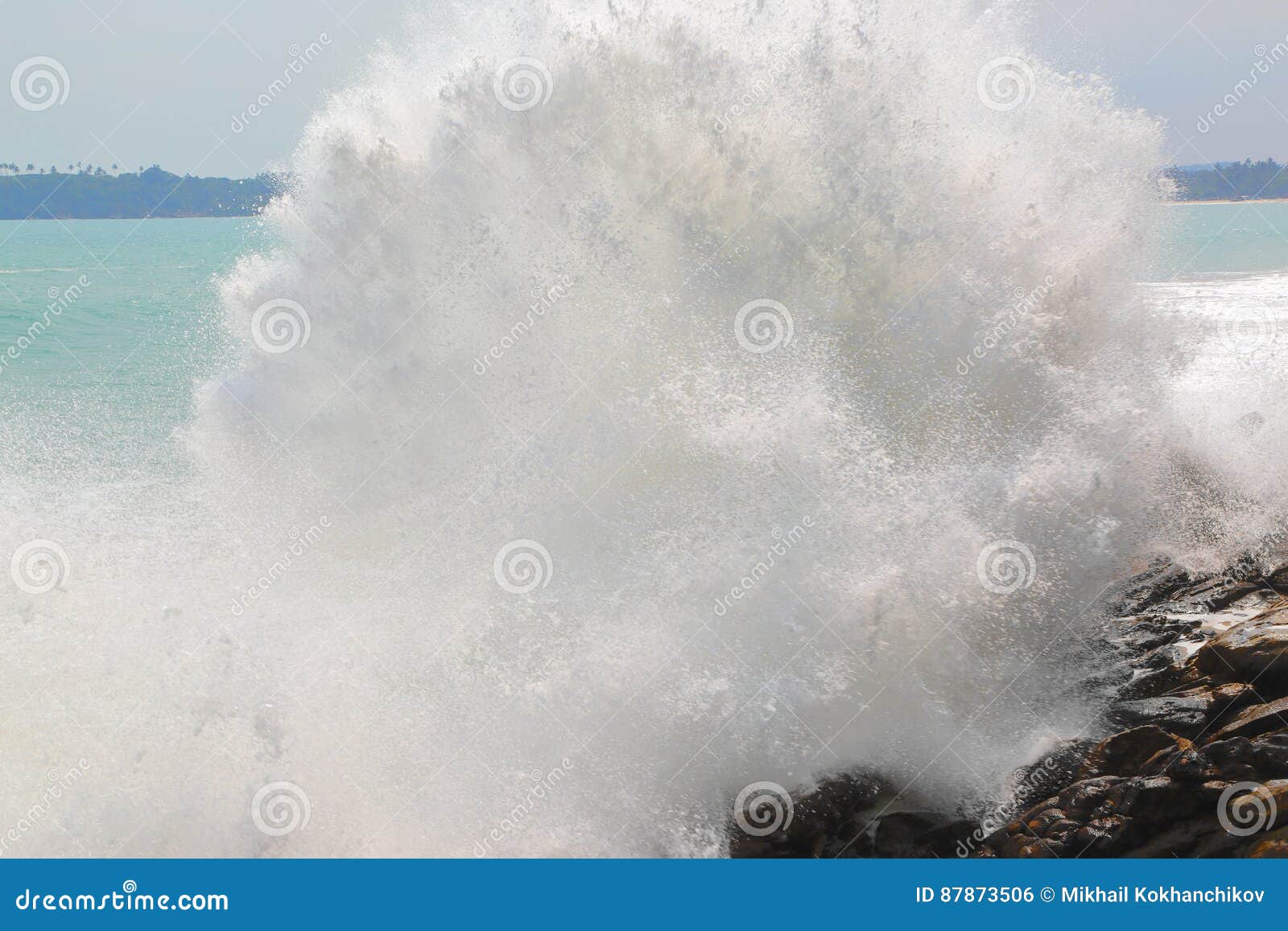 Big wave breaking on rocks stock photo. Image of splash - 87873506