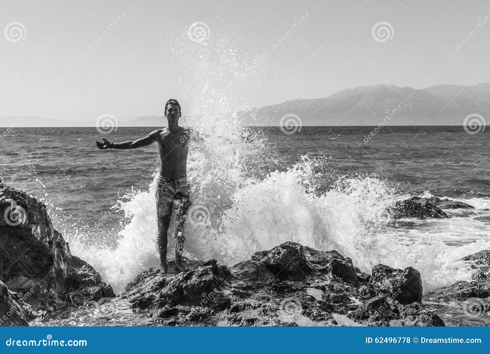 Big Wave Splash on the Man Standing on the Beach Stock Photo - Image of ...
