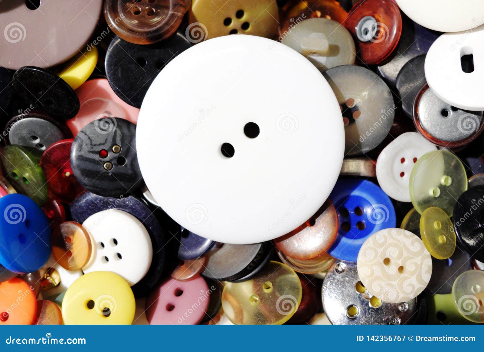 Big White Button Laying on Other Smaller Colorful Buttons Stock Image ...