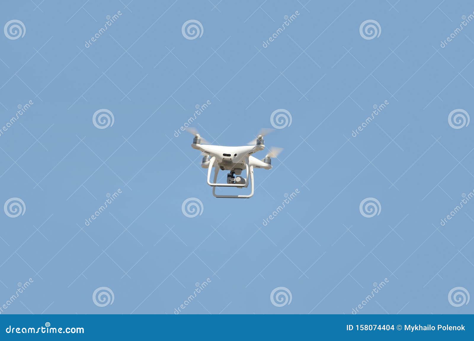 Big White Drone Hovering in a Bright Cloudless Blue Sky Stock Photo ...