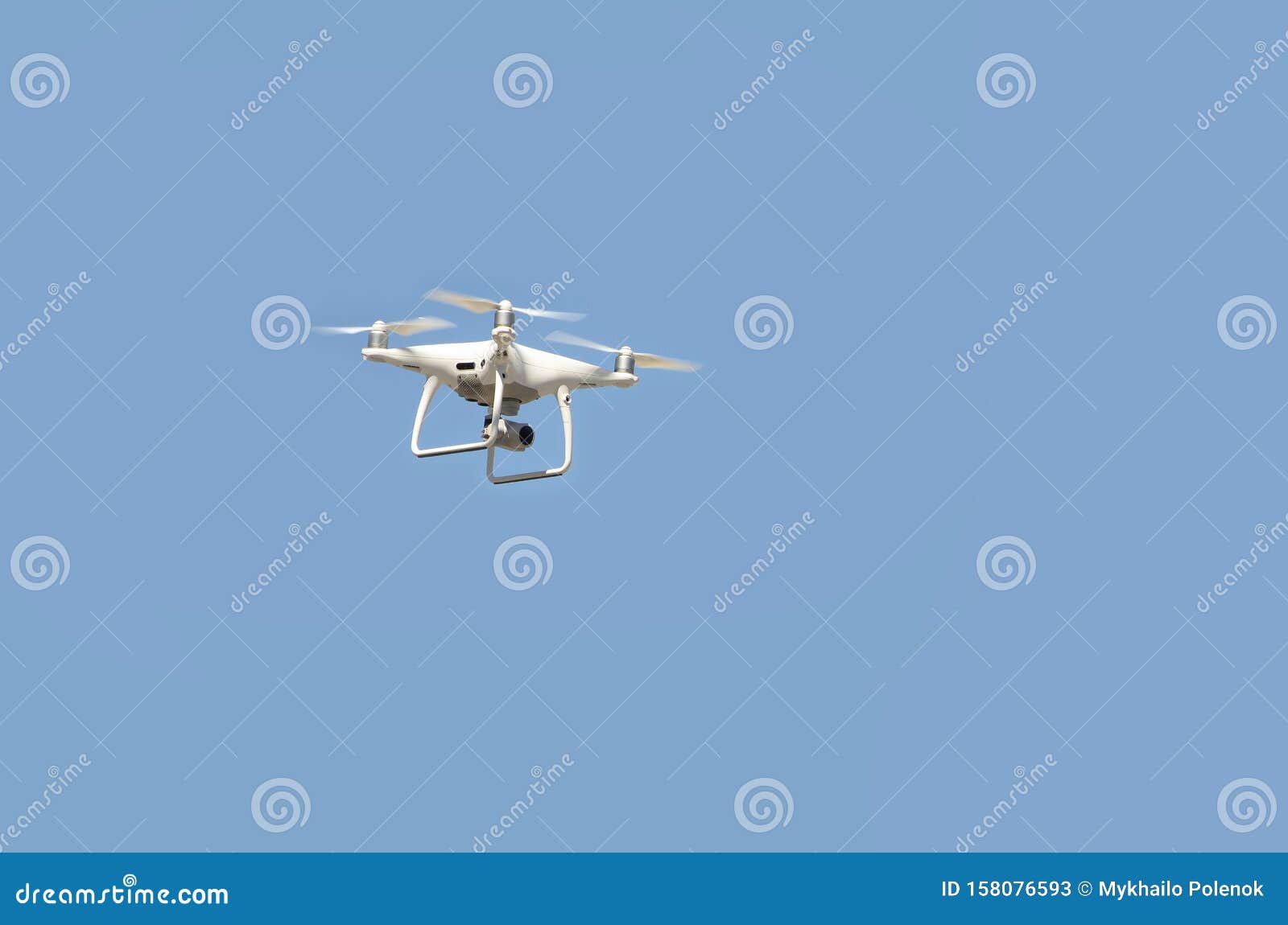 Big White Drone Hovering in a Bright Cloudless Blue Sky Stock Image ...