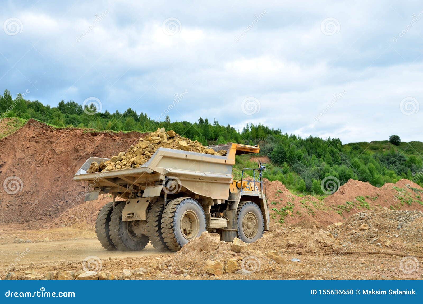Big Yellow Dump Truck Working in the Limestone Open-pit. Loading and ...