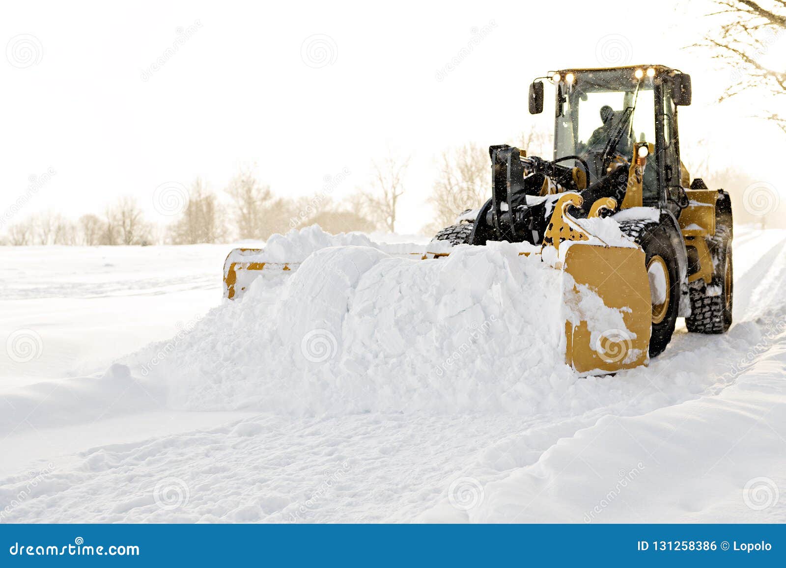 A Big Yellow Snow Plow Cleaning a Road Stock Photo - Image of hard ...