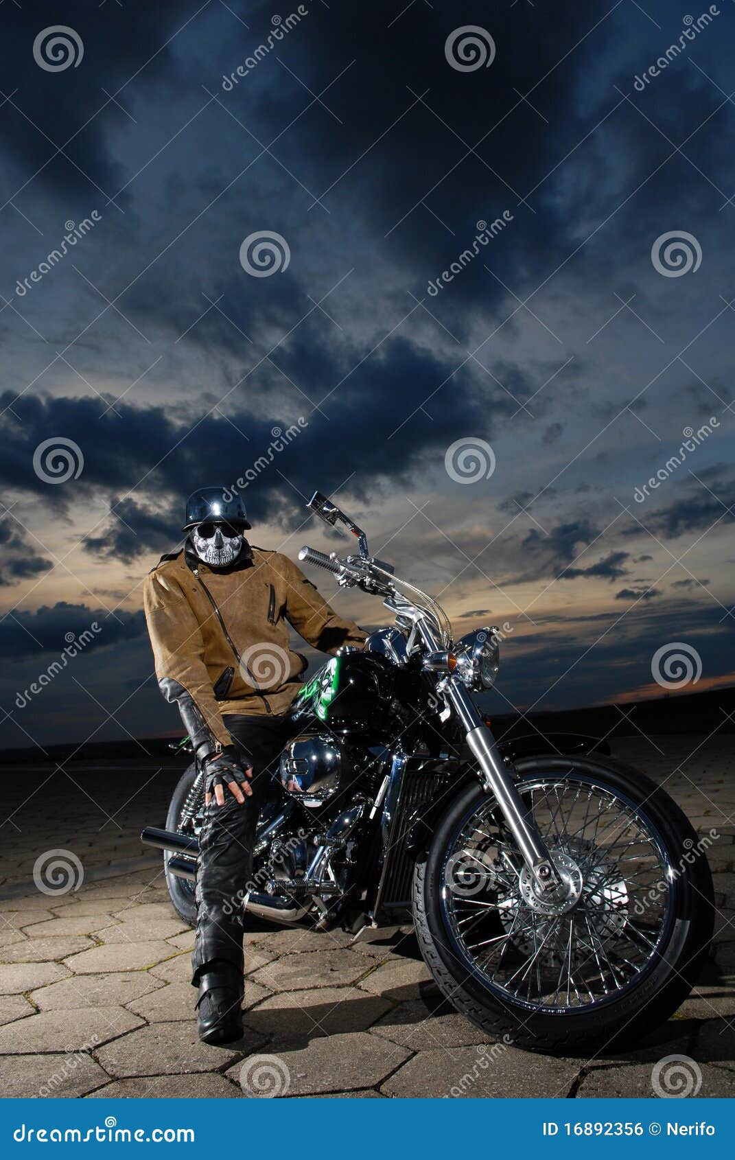 Masked Biker Sitting on Motorcycle with Dark Clouds Behind Stock Photo ...