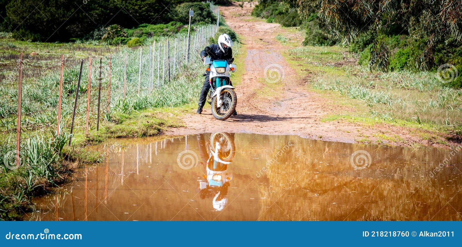 Biker on an Adventure Bike by a Puddle Stock Photo - Image of bike ...