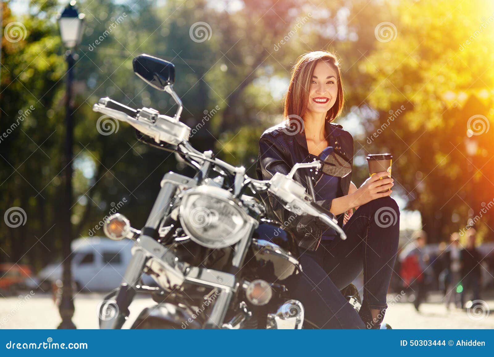Biker Girl in a Leather Jacket on a Motorcycle Drinking Coffee Stock ...