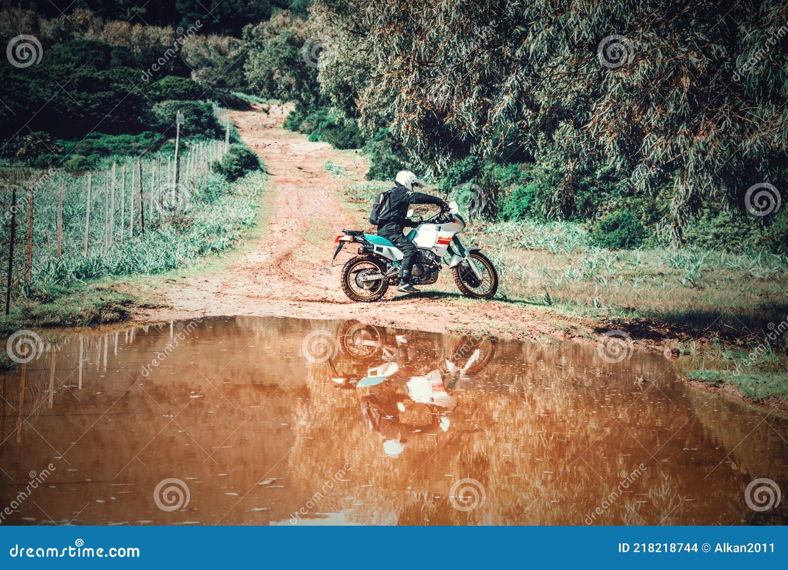 Biker and His Adventure Bike Reflected in a Puddle Stock Photo - Image ...