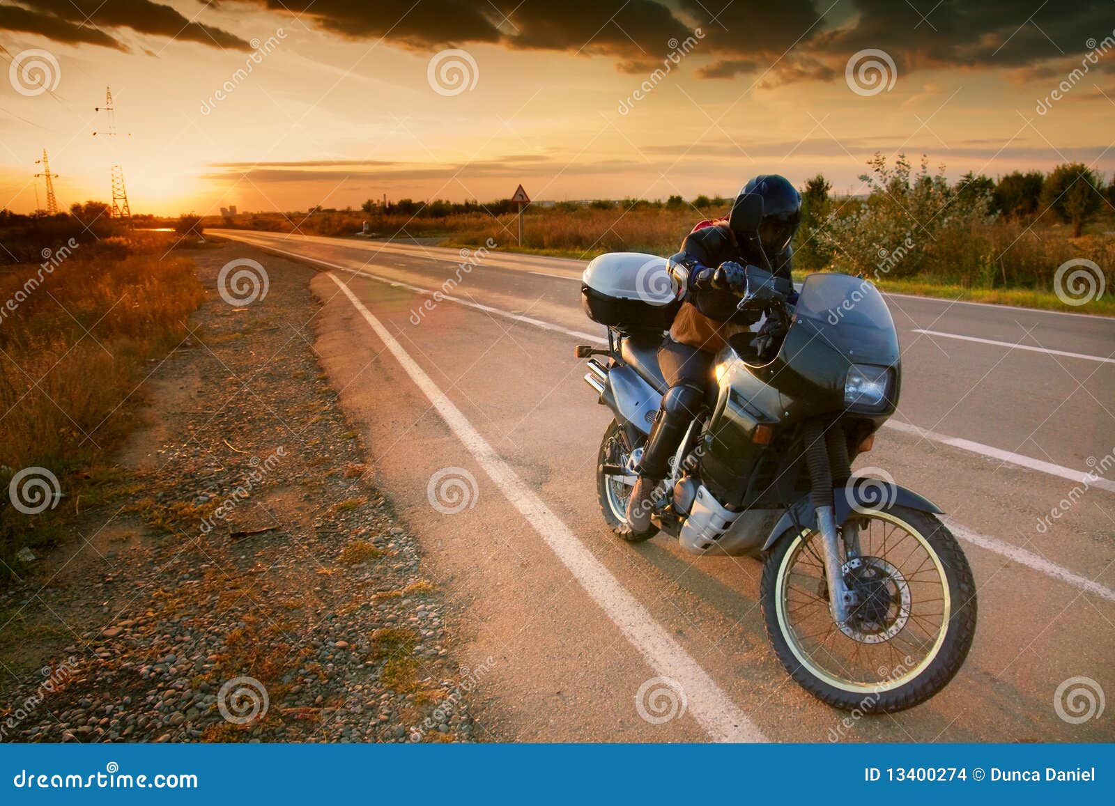 Biker and Motorcycle on Road at Sunset Stock Photo - Image of road ...