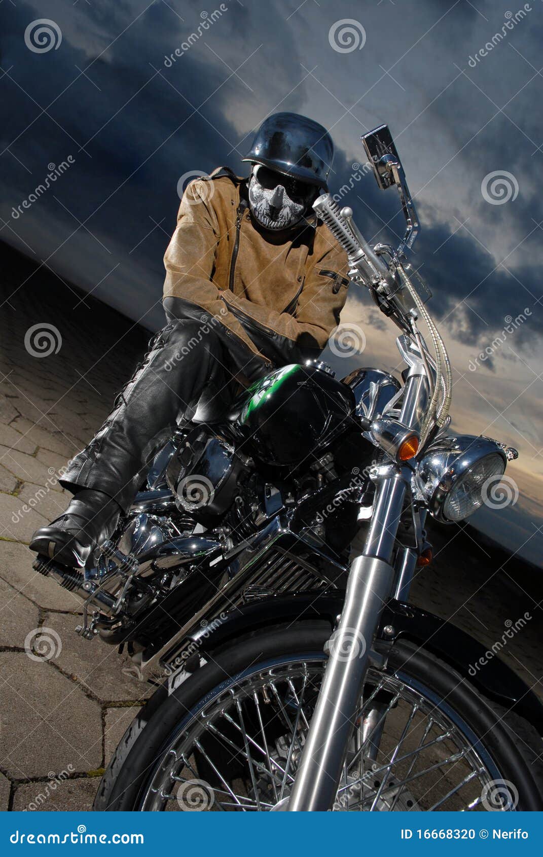 Masked Biker Sitting on a Motorcyle, with Dark Sky Background Stock ...