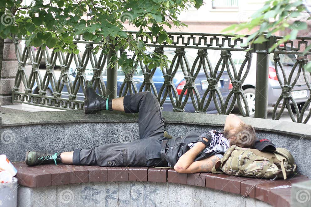 Biker sleeping on a bench editorial photography. Image of traveler ...