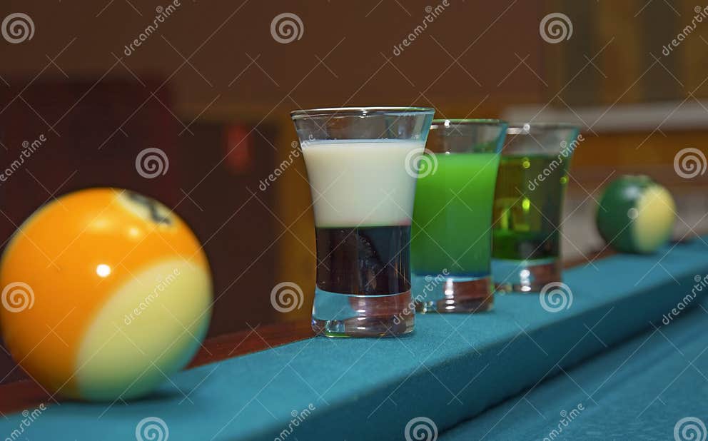 On a Billiard Table Stand with Coloured Glasses of Alcohol. Stock Photo ...