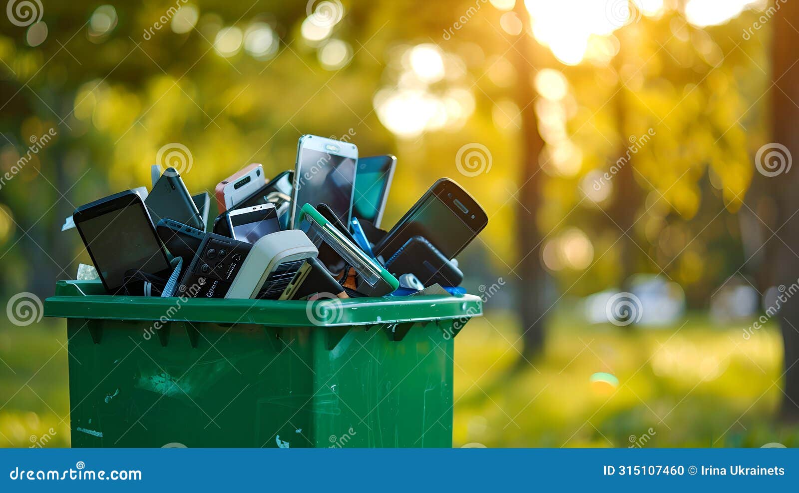 Overflowing Green Bin with Discarded Electronics in a Park at Sunrise ...