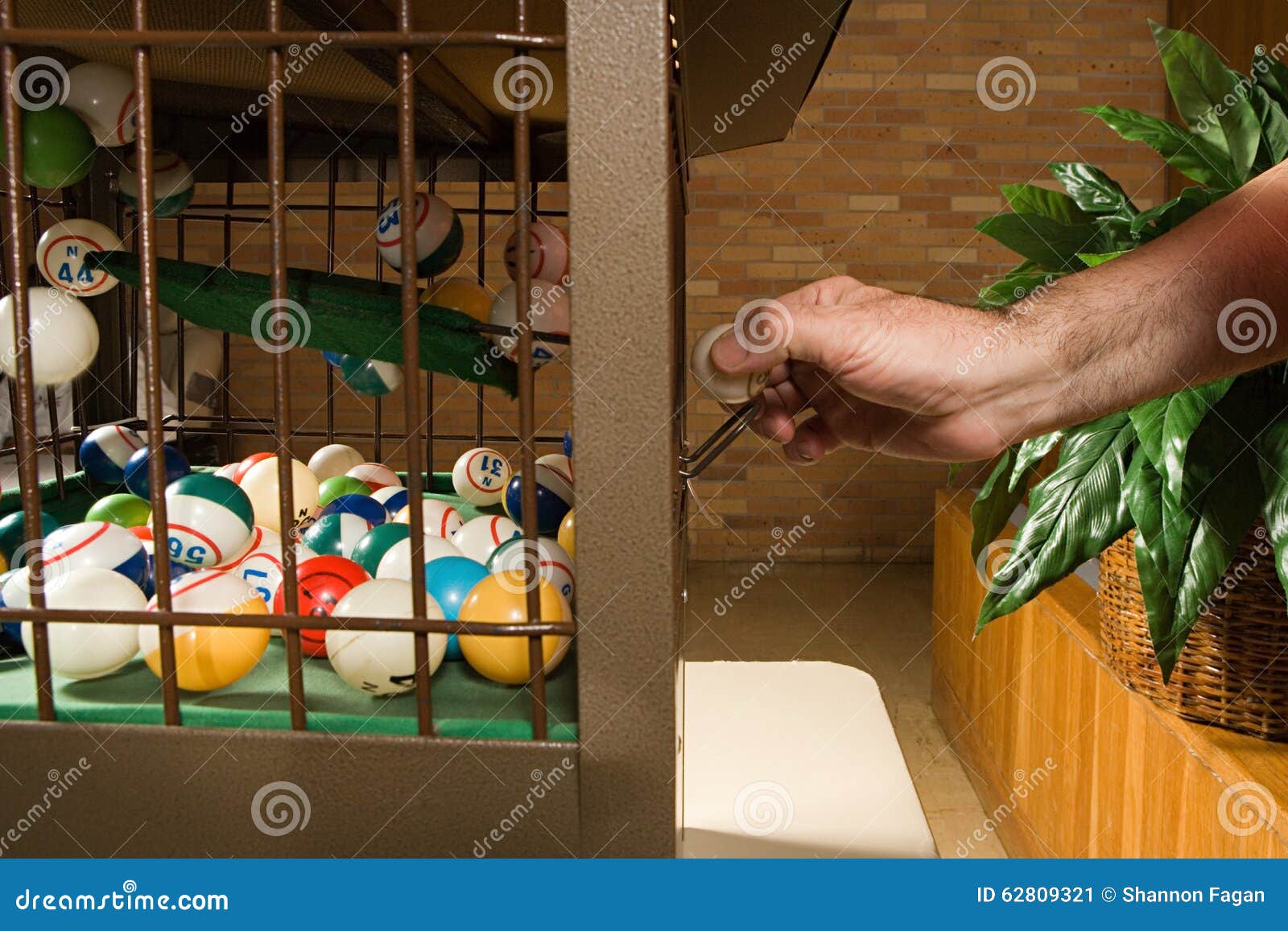 Bingo Caller Reaching for a Bingo Ball Stock Image - Image of bingo ...