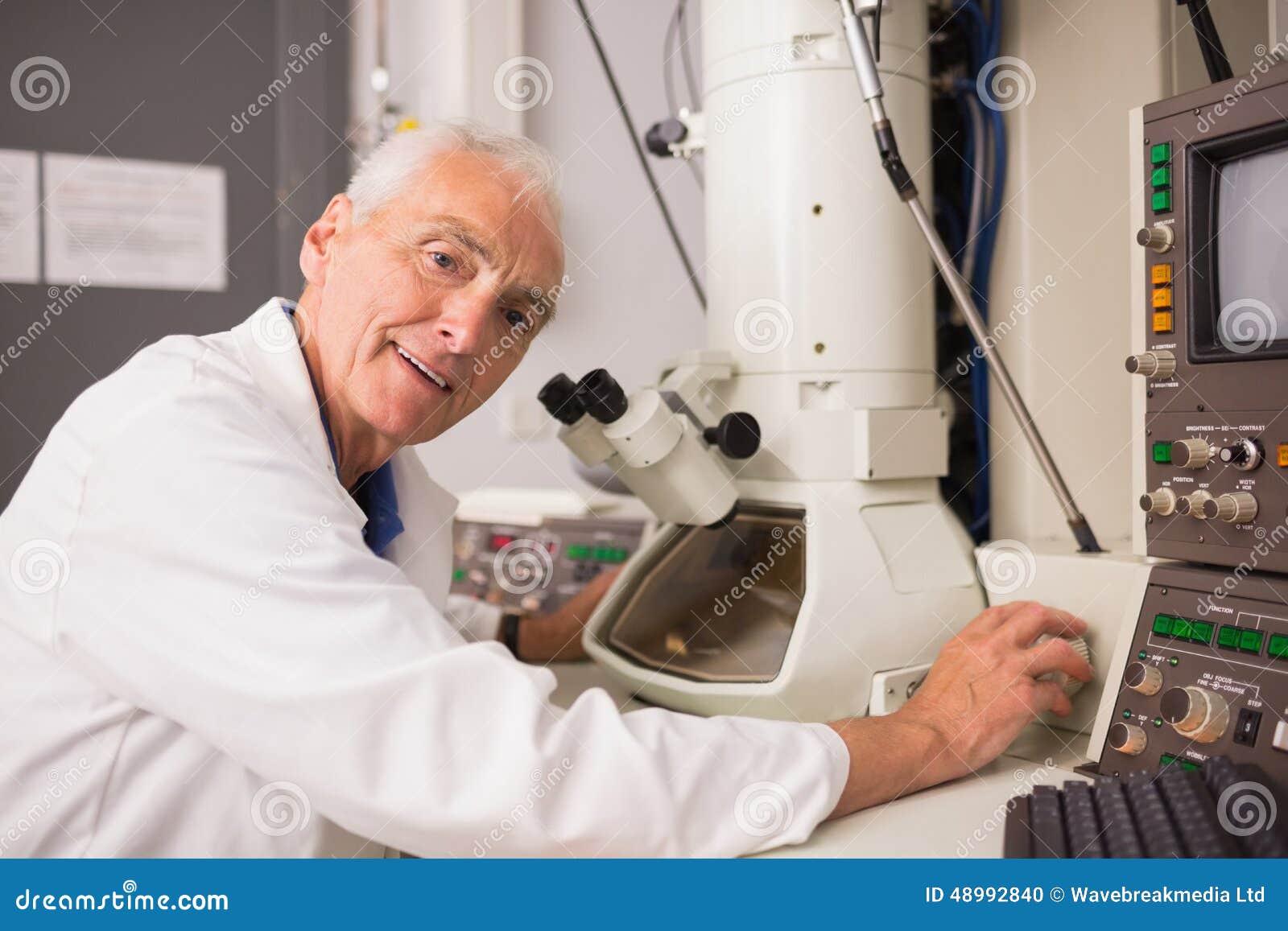 Biochemist Using Large Microscope and Computer Stock Photo - Image of ...