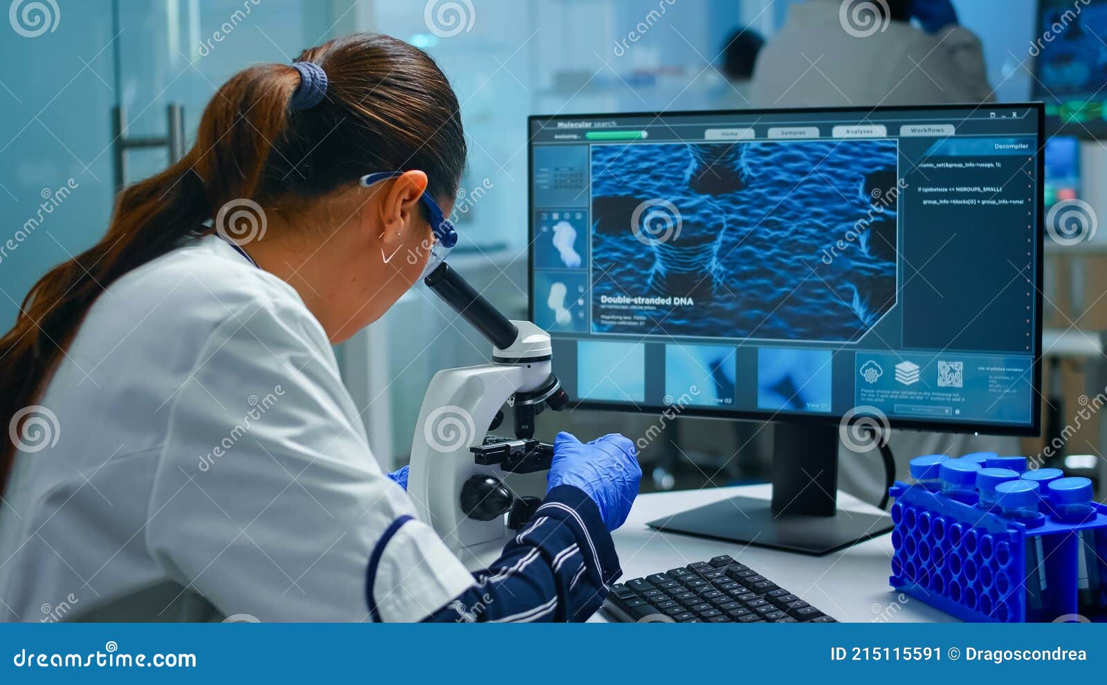 Biochemist Using Microscope and Writing at Computer Working in Equipped ...