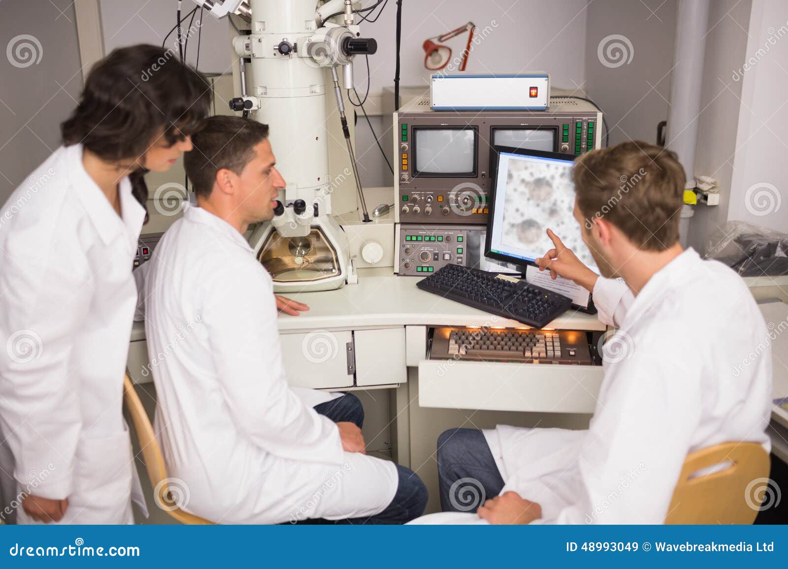 Biochemistry Students Using Large Microscope and Computer Stock Image ...