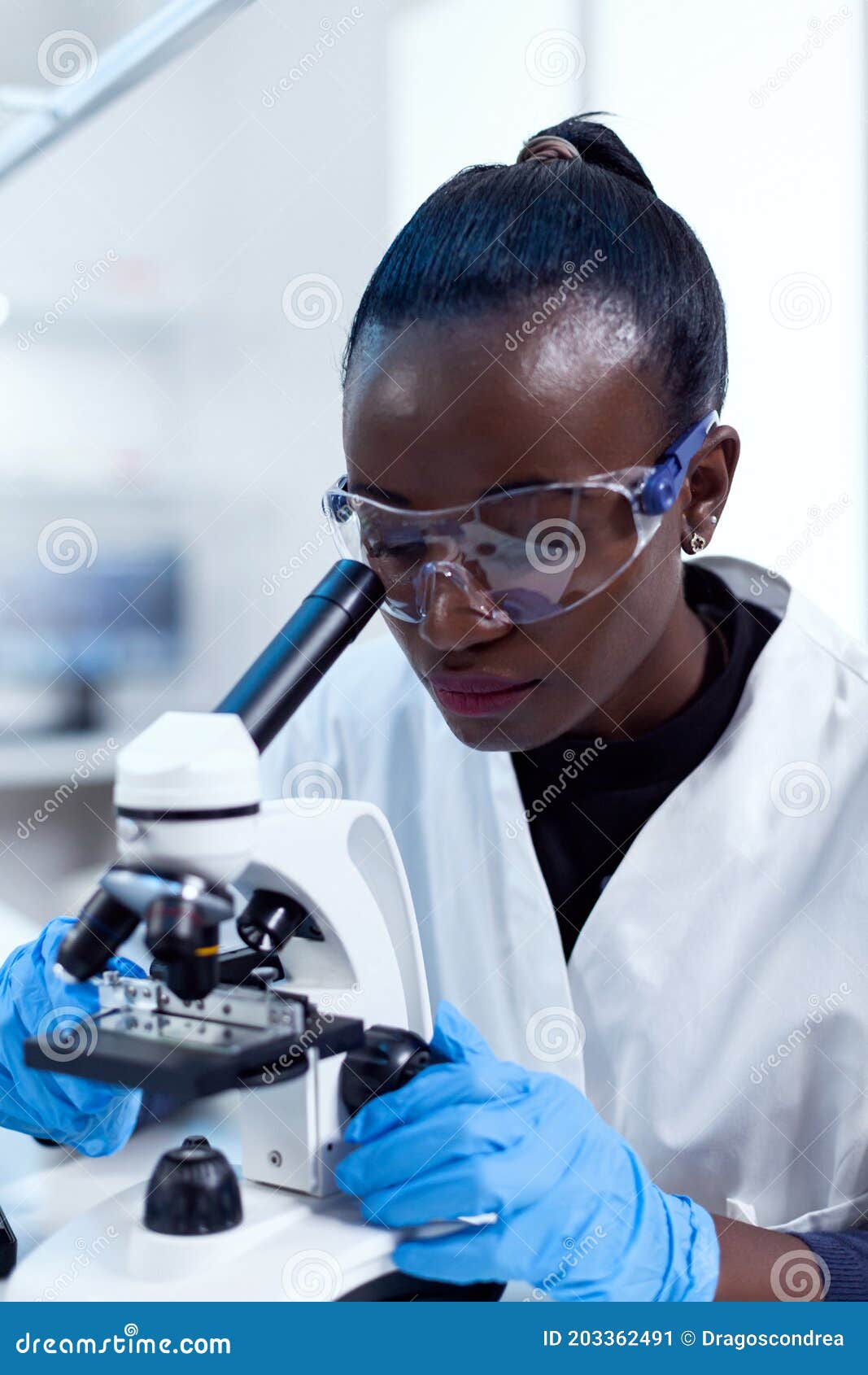African Biochemistry Doctor Examining Chemical Test Using Microscope ...