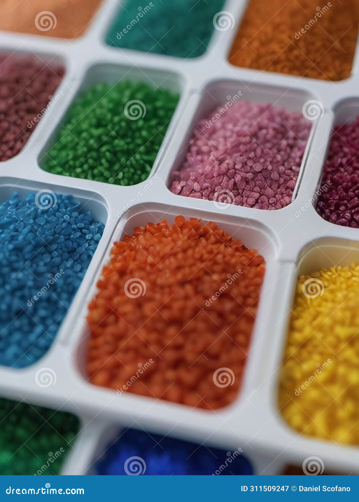 Biodegradable Plastic Granules in a Range of Hues are Spread Out on a ...