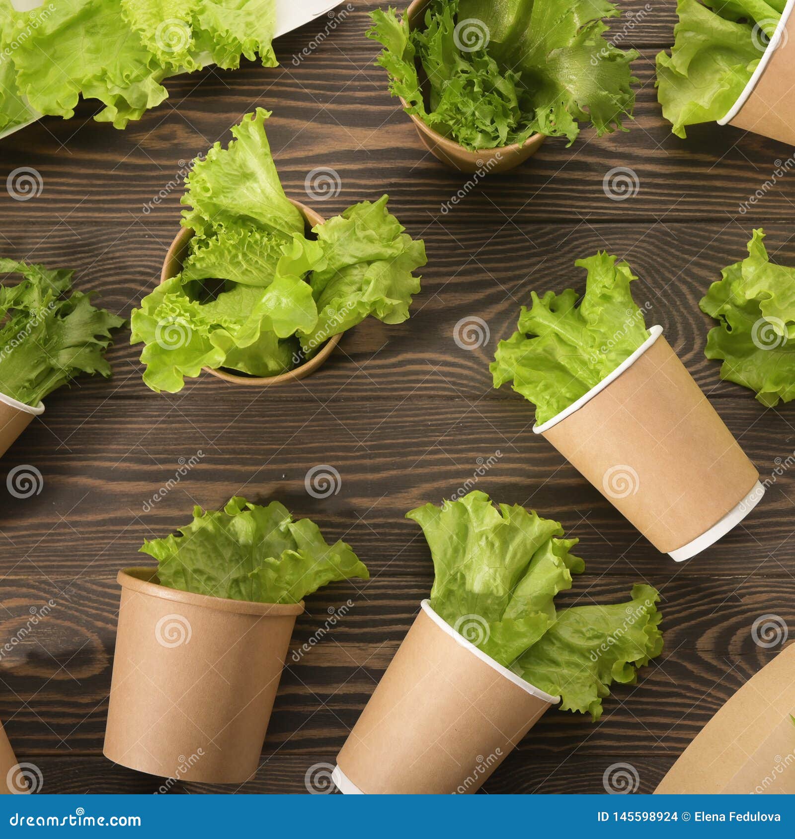 Biodegradable Tableware and Greens on Wooden Background. Secondary ...