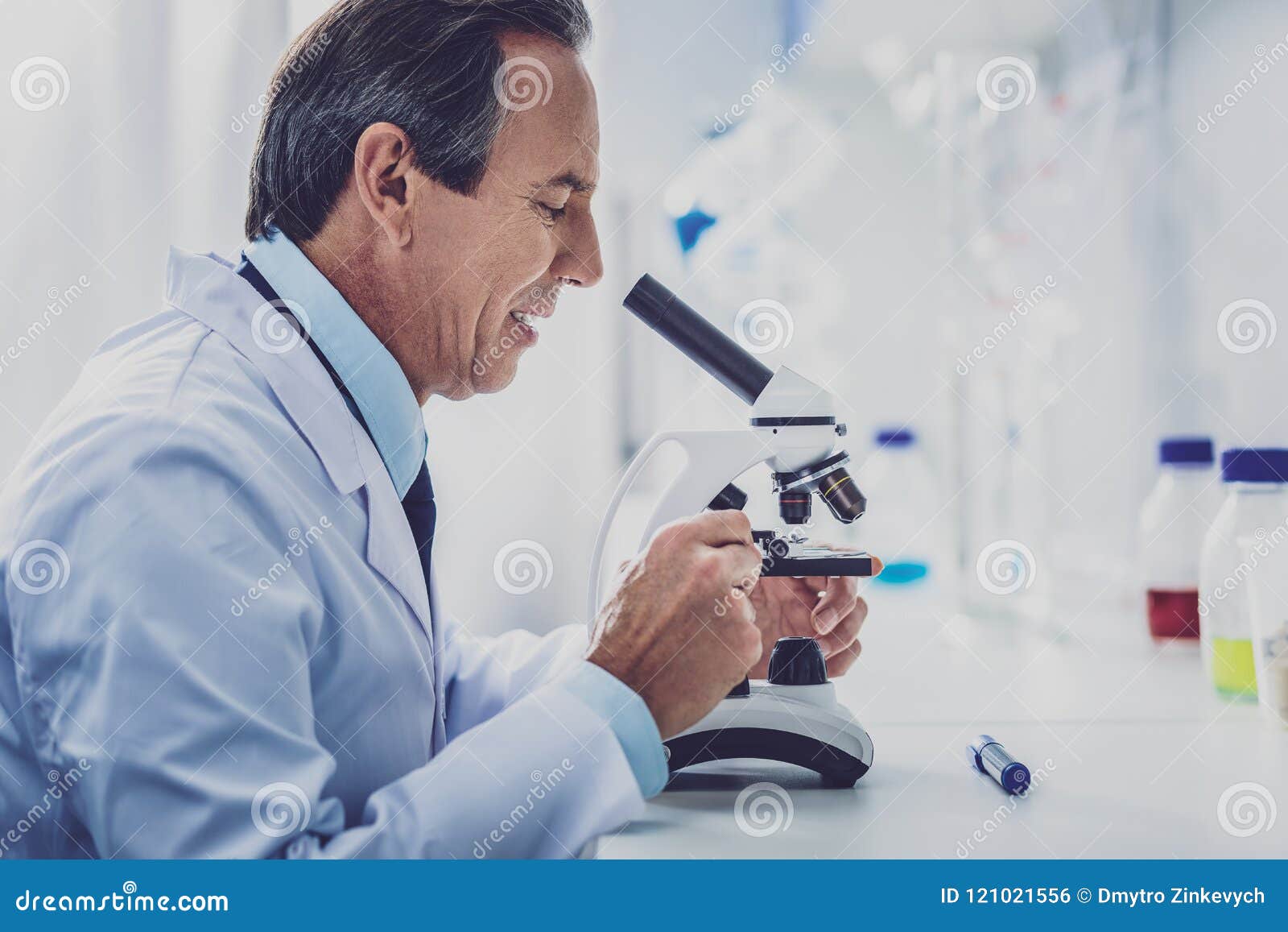 Bioengineer Wearing White Uniform Looking into Microscope Stock Photo ...