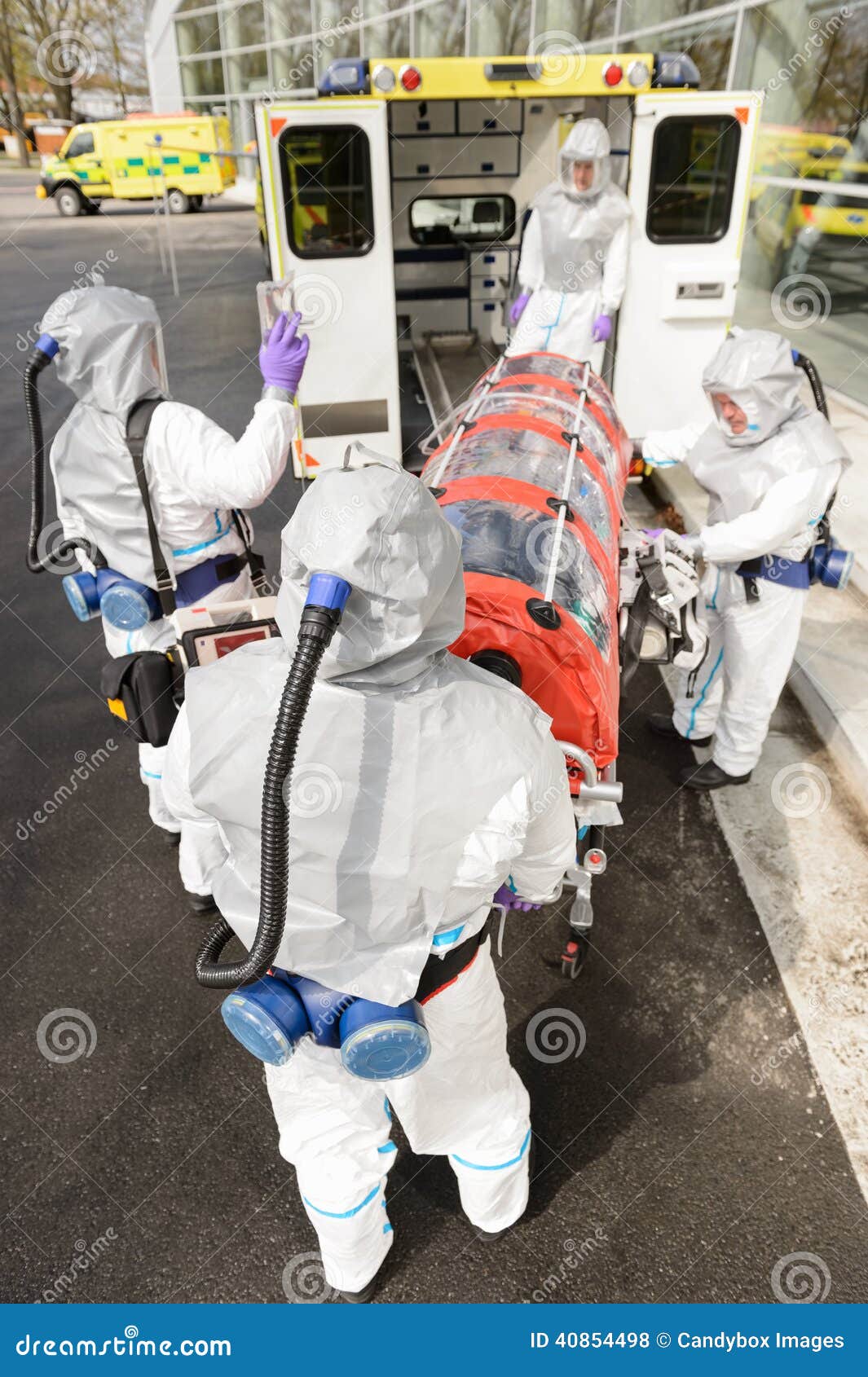 Biohazard Team Loading Stretcher in Ambulance Stock Photo - Image of ...