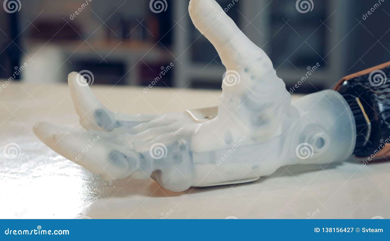 Bionic Hand is Clenching Its Fingers while Lying on the Table Stock ...