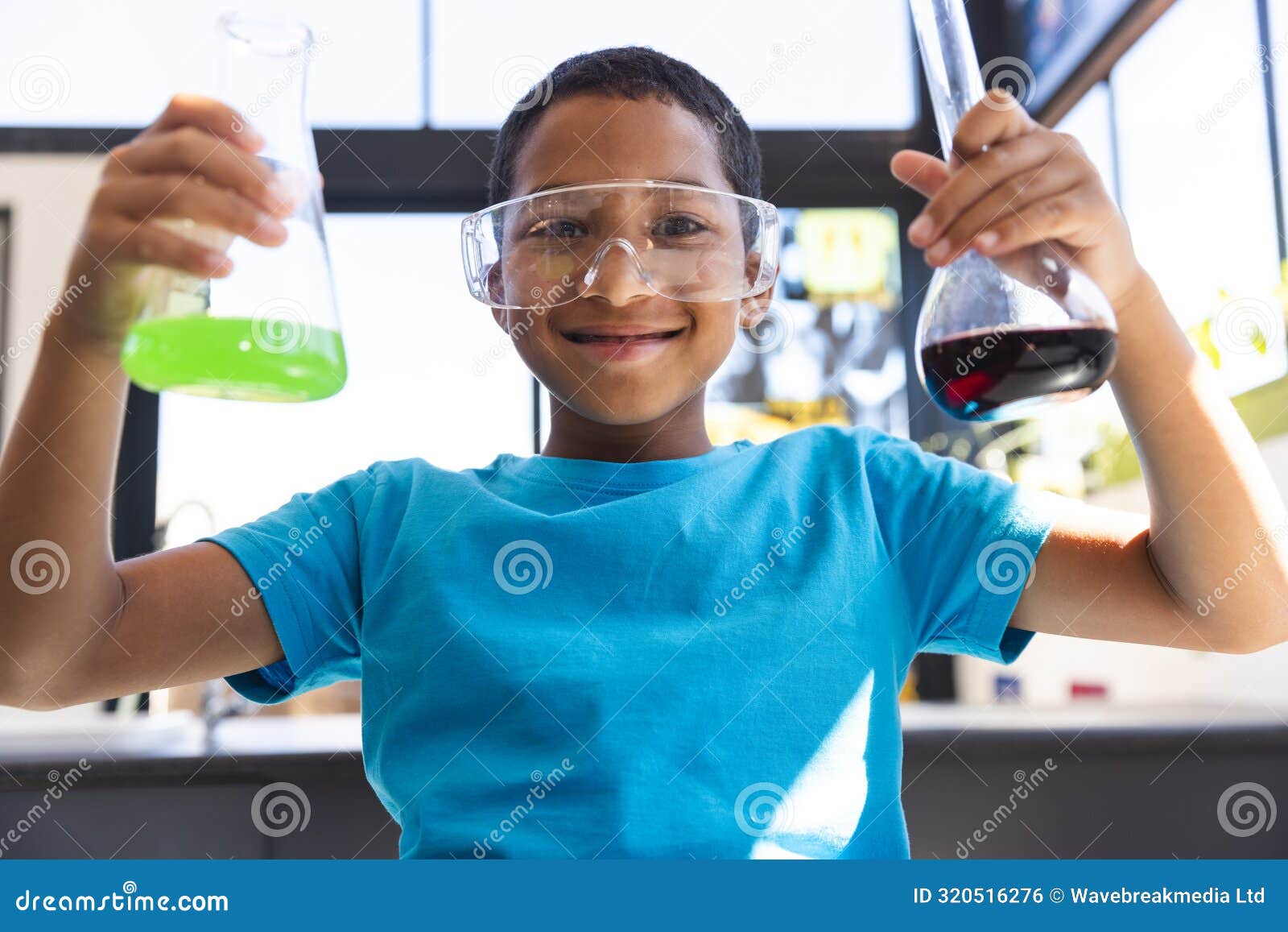 Biracial Boy Enjoys a Science Experiment at School in the Classroom ...