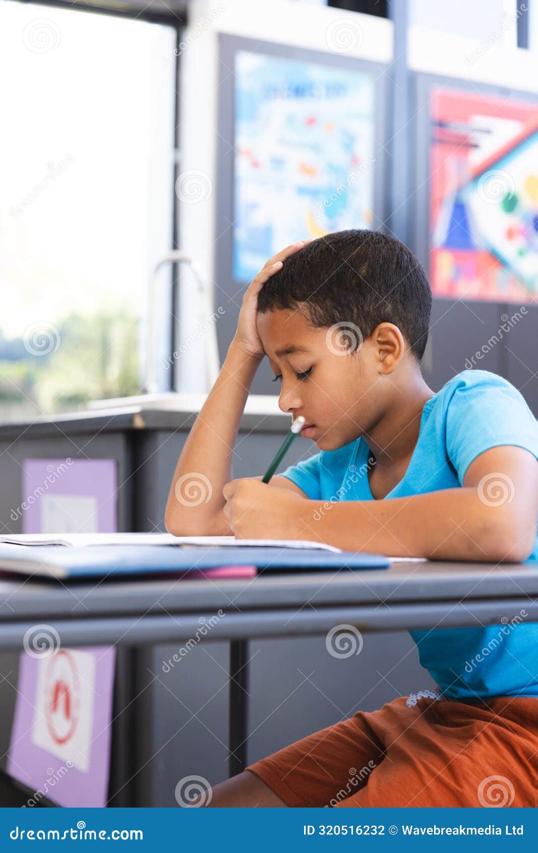Biracial Boy Focused on Schoolwork at School Stock Photo - Image of ...