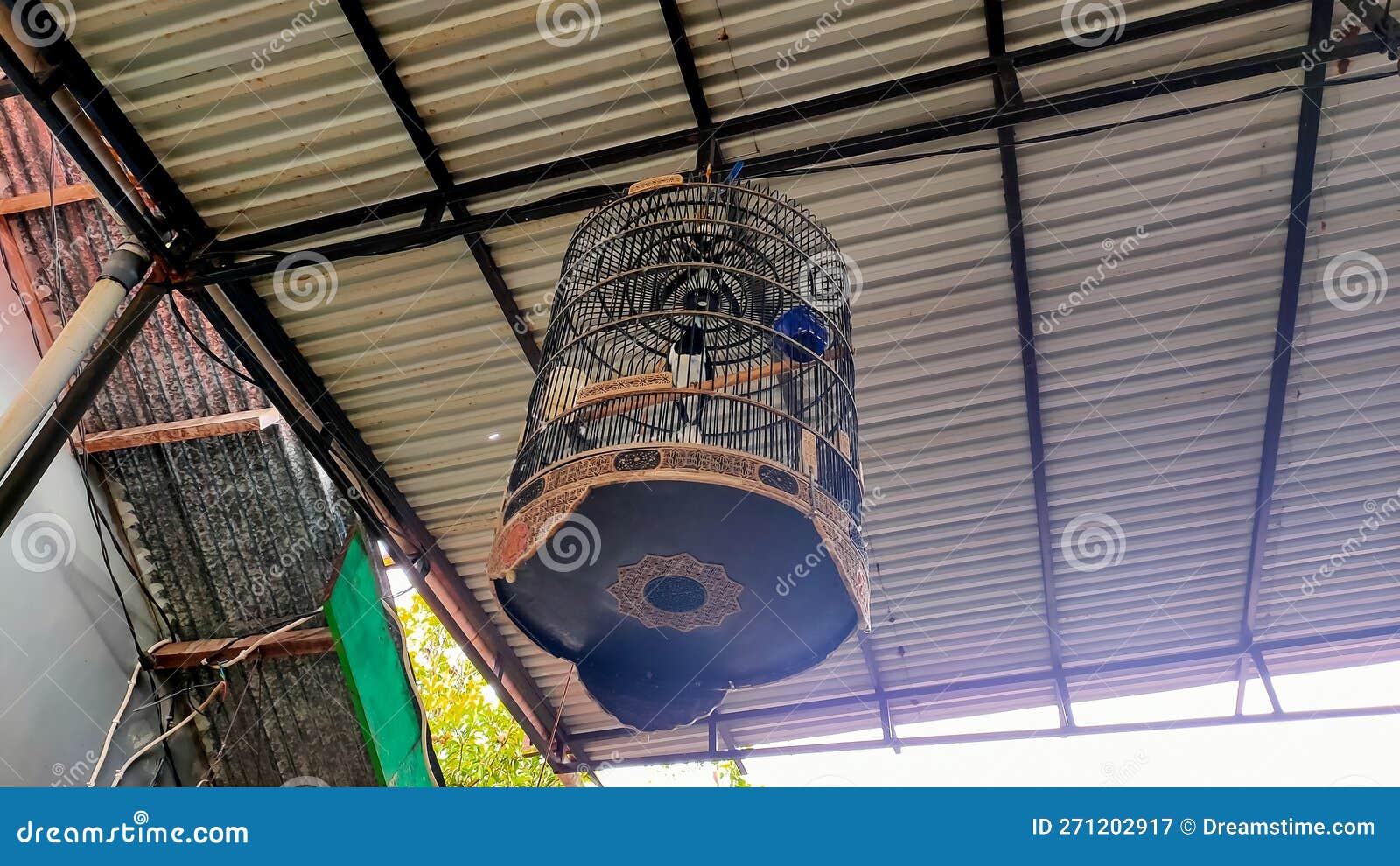 A Bird Cage is Hung in Front of the Terrace of a Resident S House Stock ...