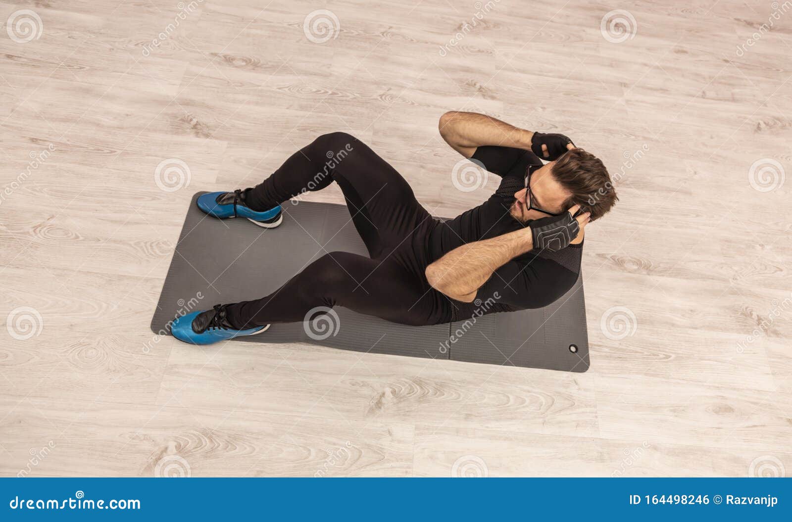 Man Doing Sit-ups stock photo. Image of abdomen, glasses - 164498246