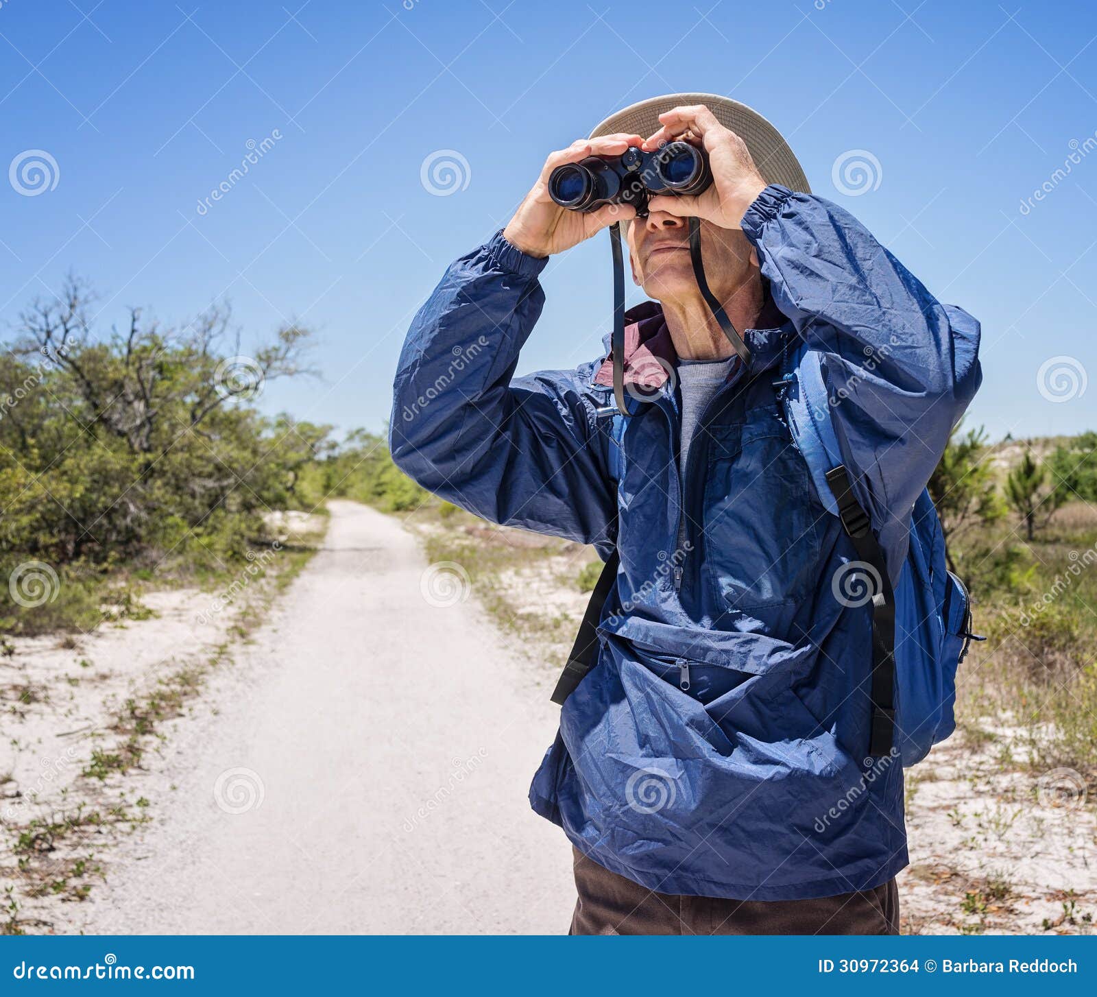 Birdwatching Man Hiking on a Path in National Park Stock Photo - Image ...