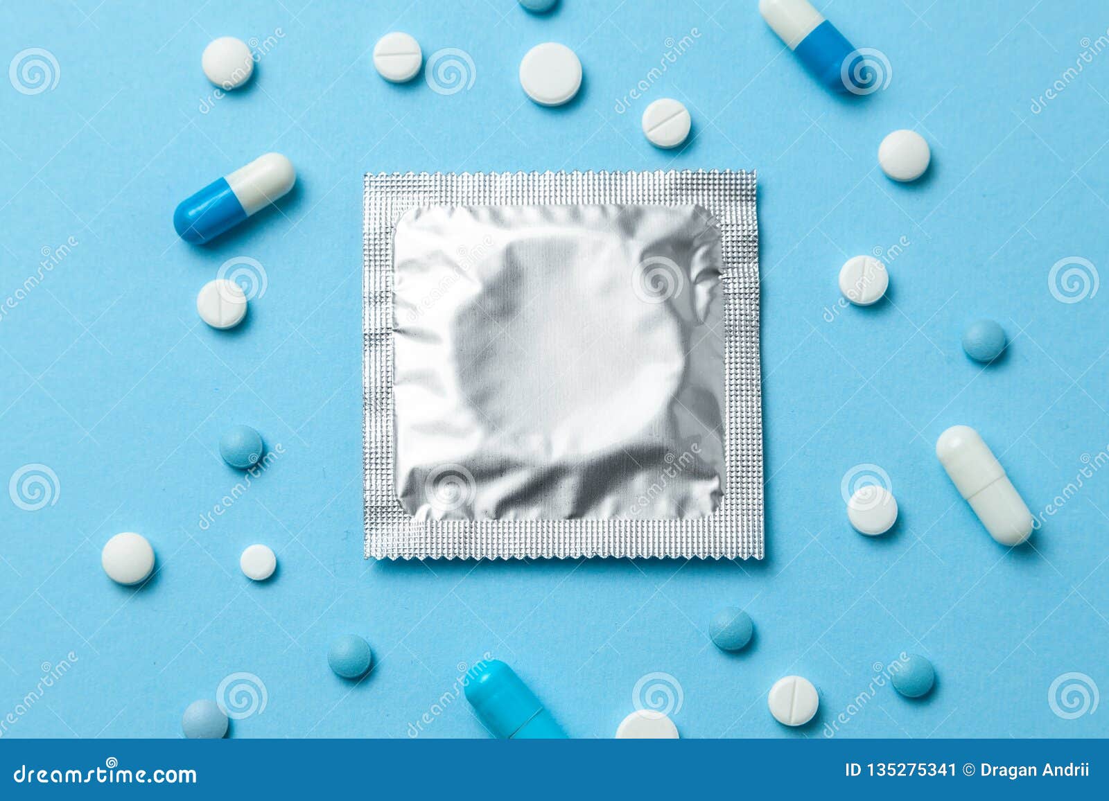 Birth Control Pills and Condom in Package on Blue. the Concept of ...