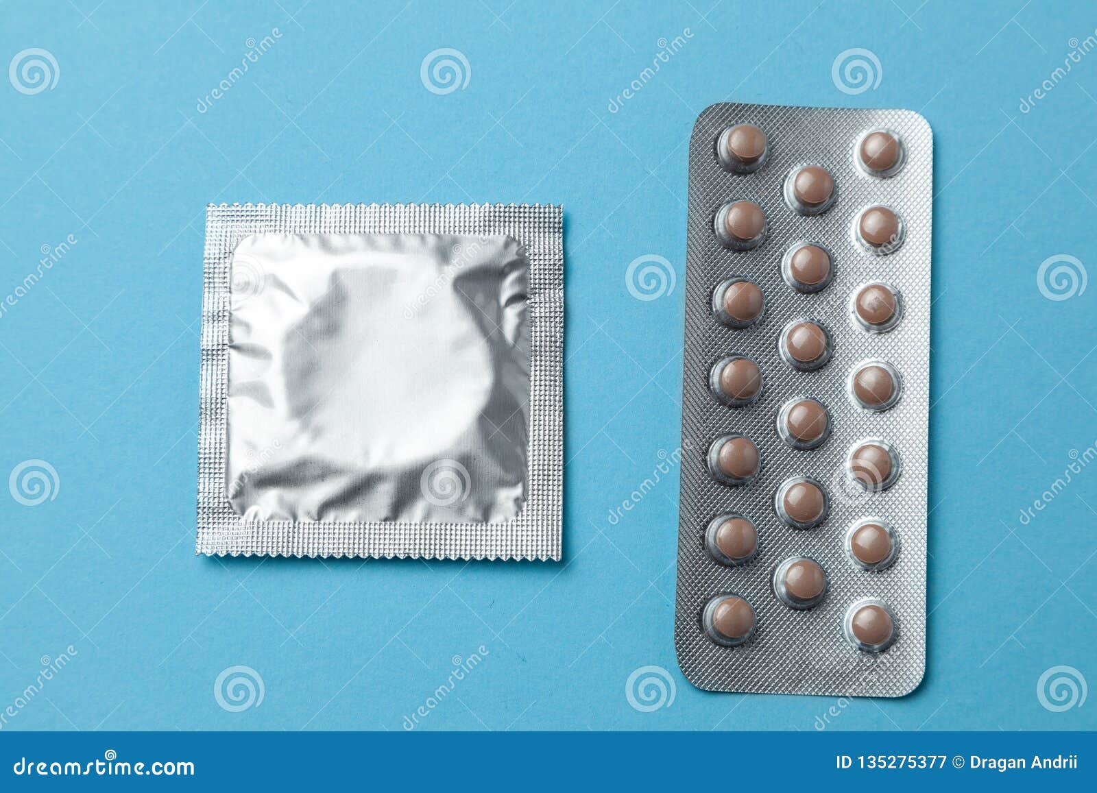 Birth Control Pills and Condom in Package on Blue. the Concept of ...