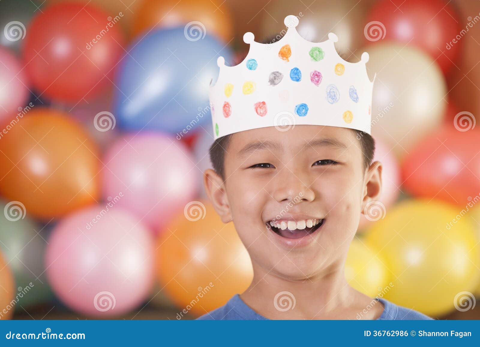 Birthday Boy Wearing a Crown in Front of Balloons Stock Photo - Image ...