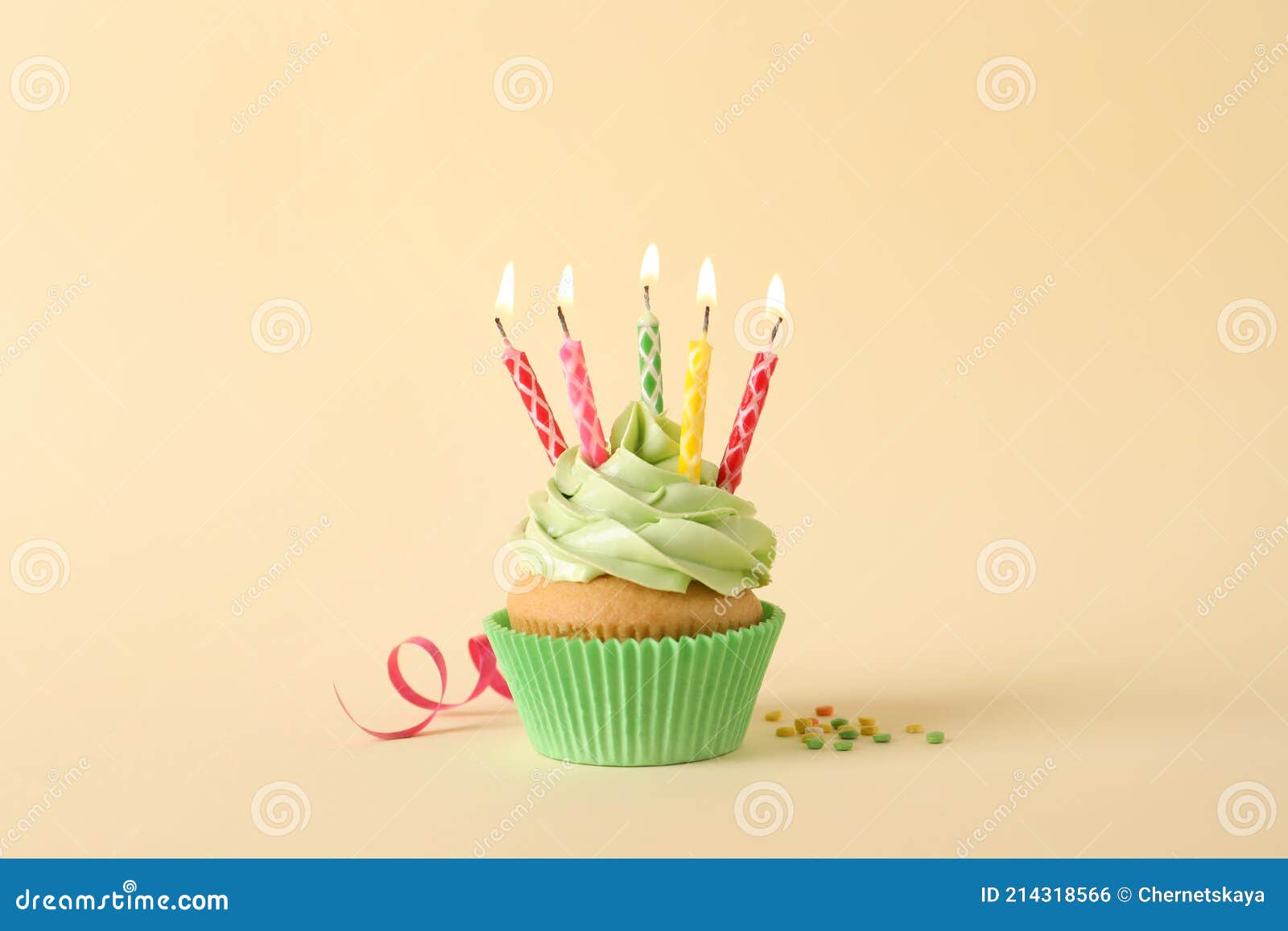 Birthday Cupcake with Burning Candles, Streamer and Sprinkles on Beige ...