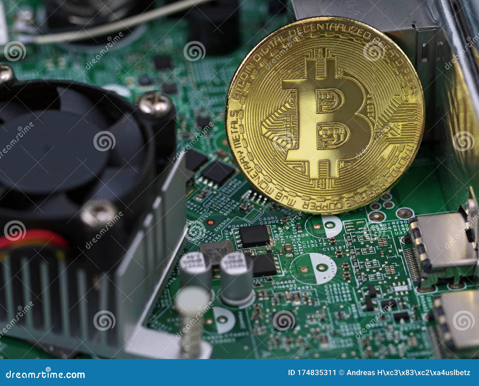 Bitcoin Golden Coin on Computer Motherboard between Microchips and ...
