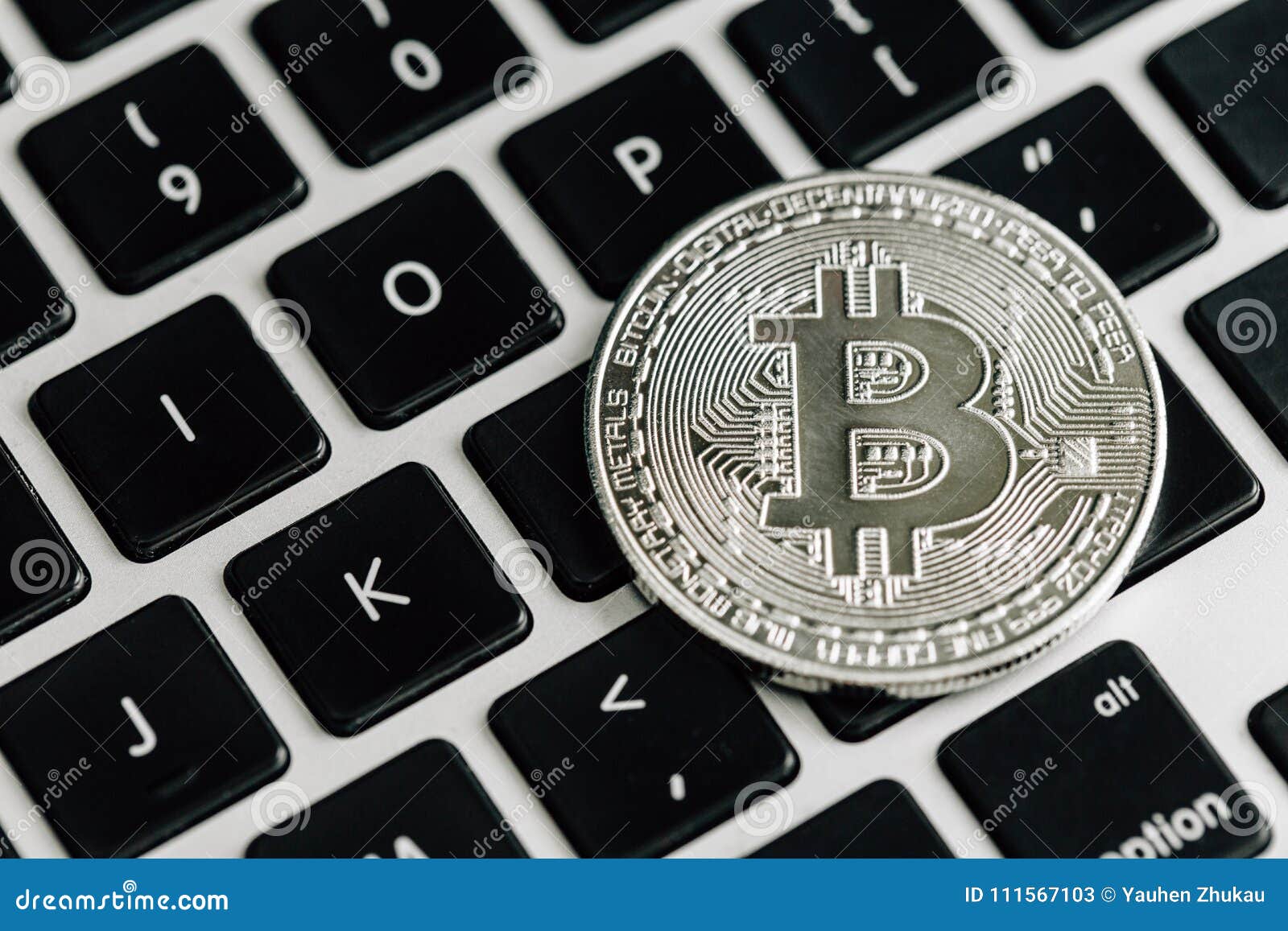 Bitcoin Silver Coin on Computer Laptop Keyboard. Virtual Cryptocurrency ...