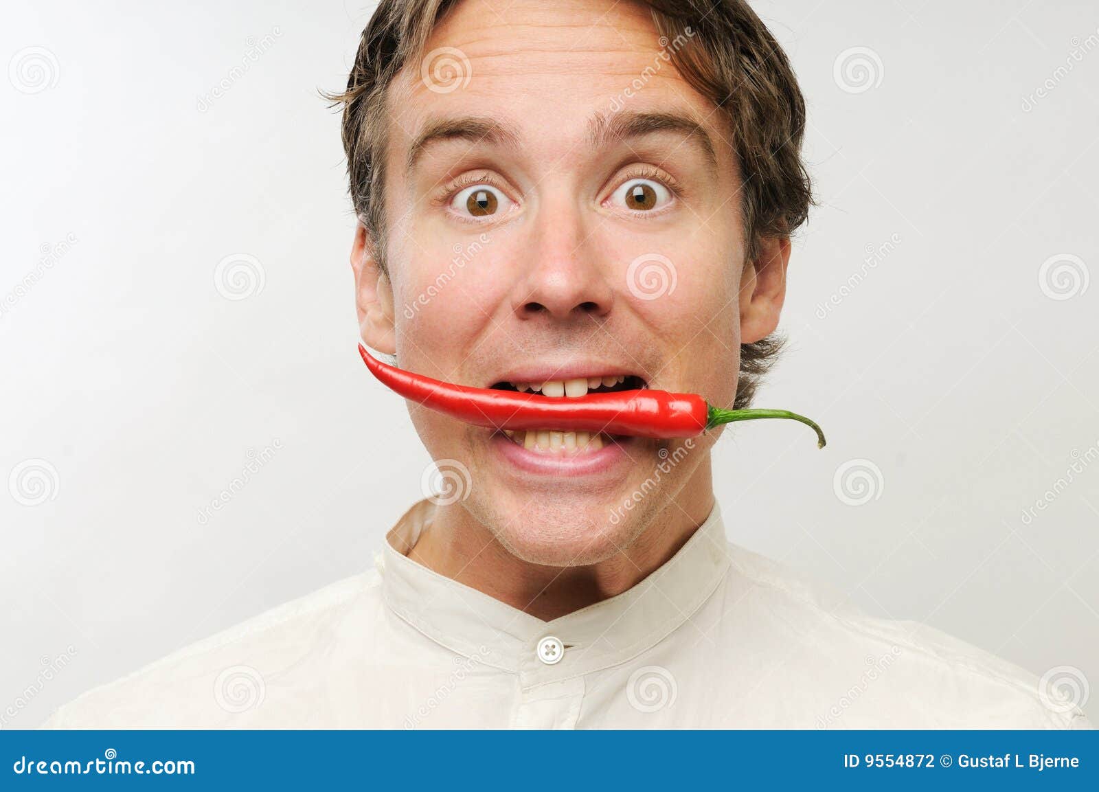 Bite the chili stock photo. Image of isolated, teeth, face - 9554872