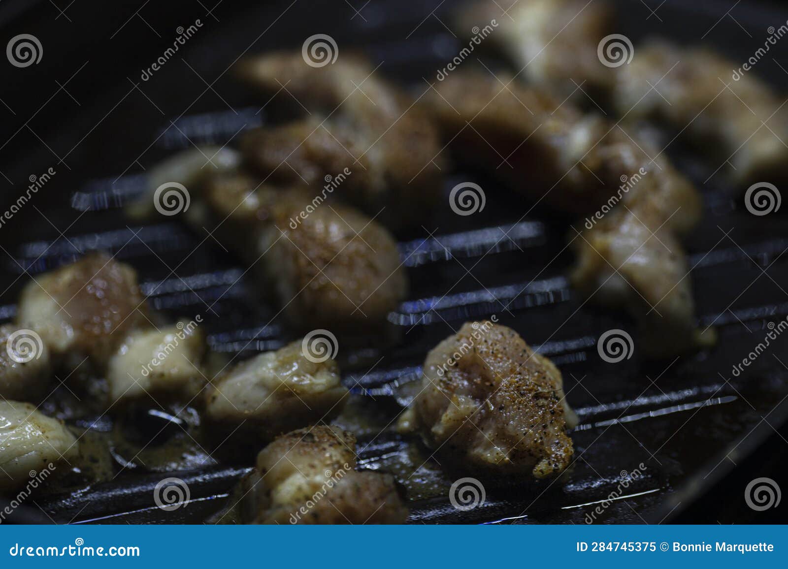 Bite Sized Pieces of Chicken Grilling on a Griddle. Stock Image - Image ...