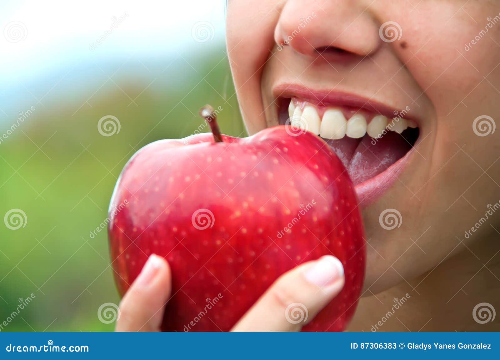Biting an apple stock image. Image of apple, implant - 87306383