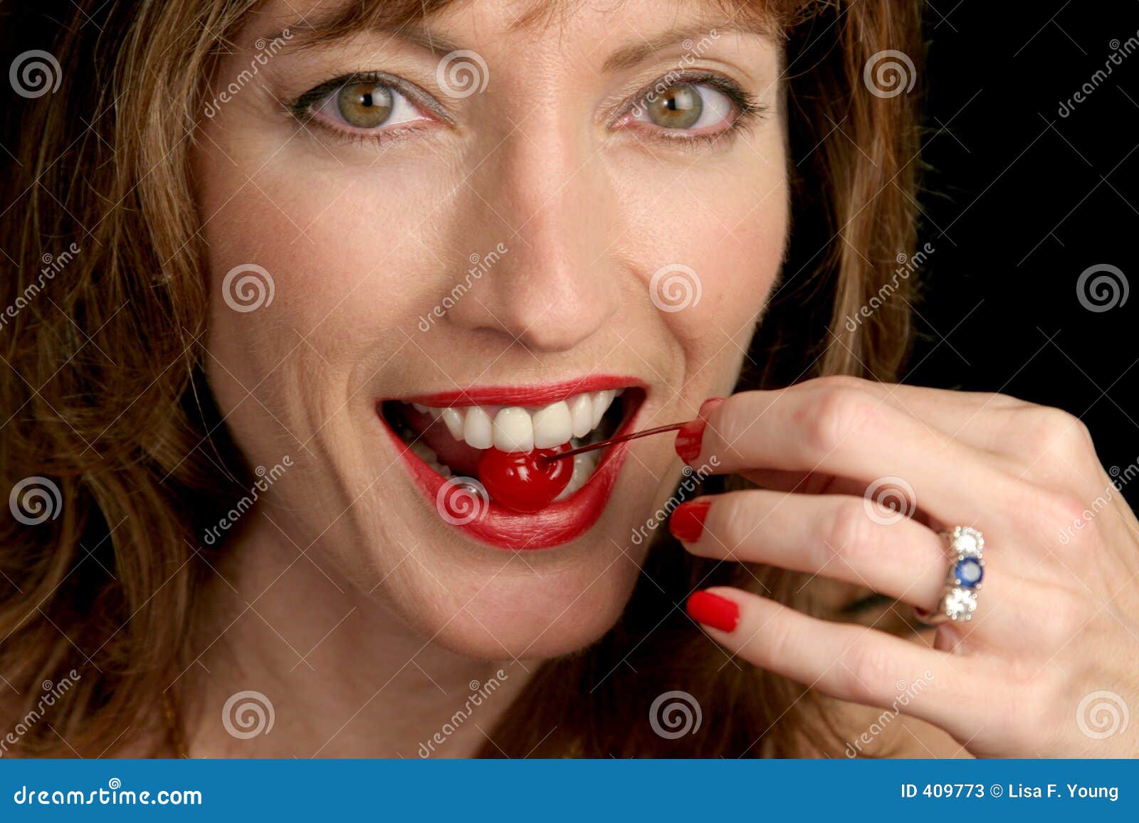 Biting the Cherry stock image. Image of attractive, martini - 409773