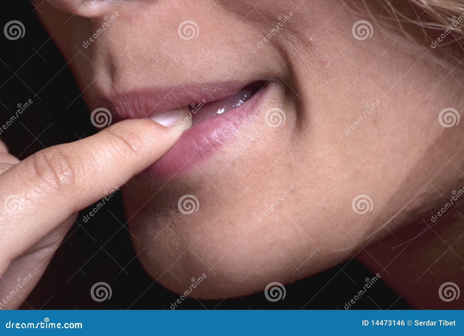 Biting the finger stock photo. Image of tongue, finger - 14473146