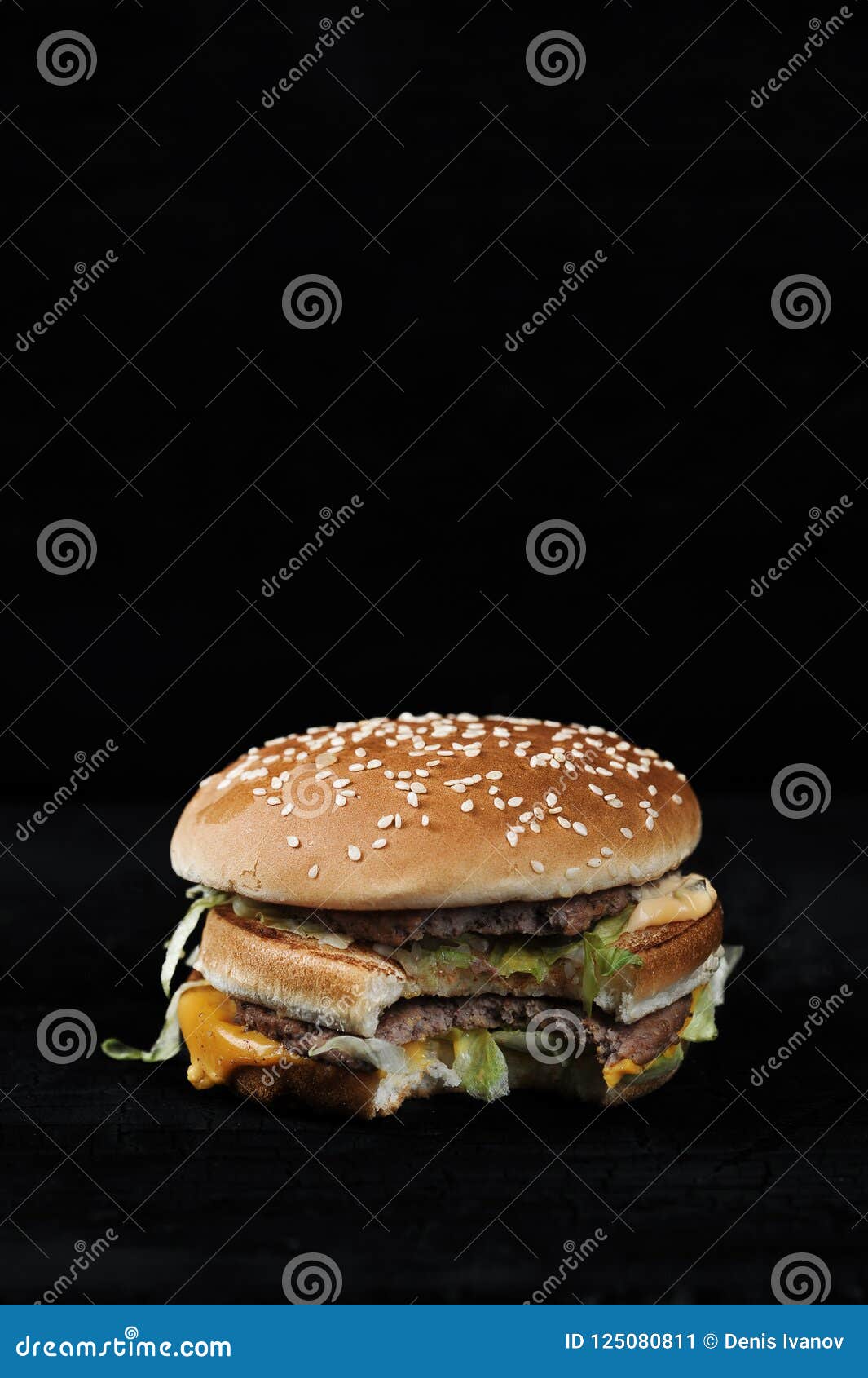 Bitten Burger on a Dark Rustic Stock Image - Image of sandwich ...