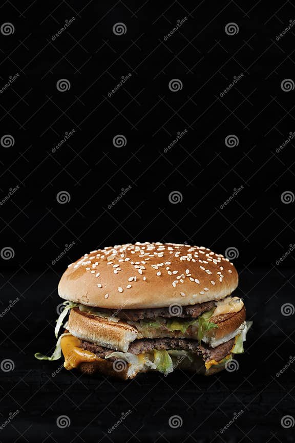 Bitten Burger on a Dark Rustic Stock Image - Image of sandwich ...
