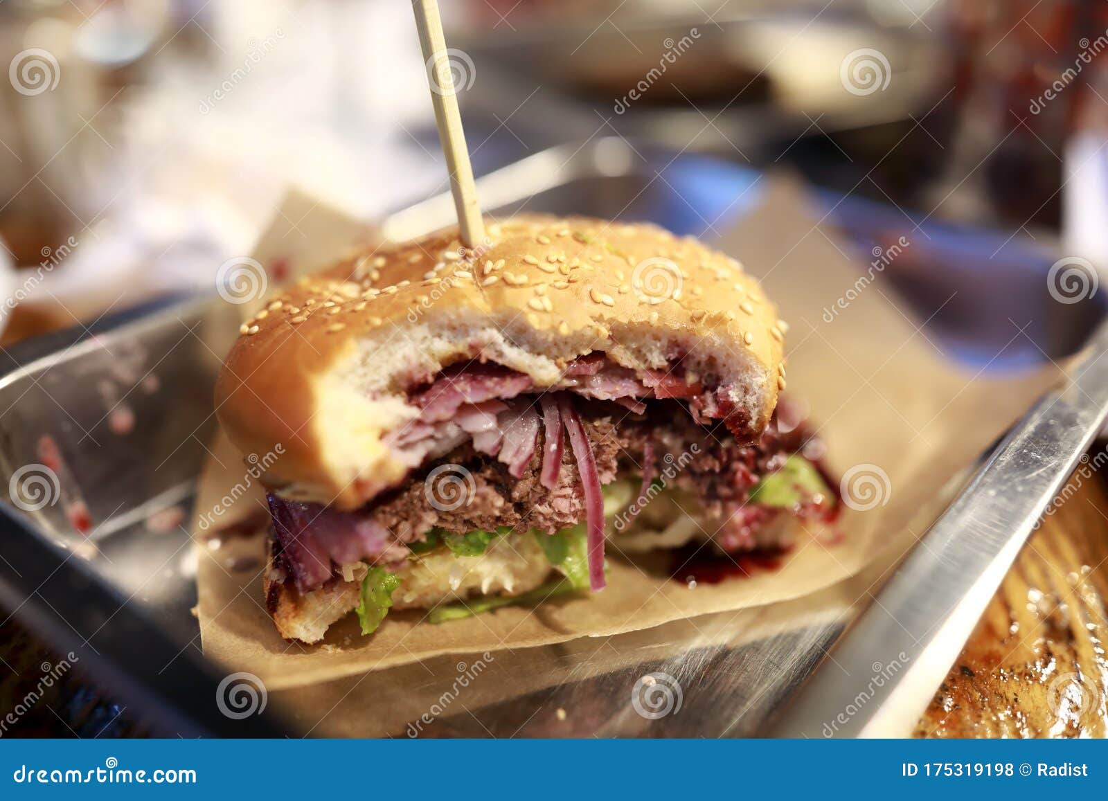 Bitten burger on plate stock photo. Image of lettuce - 175319198