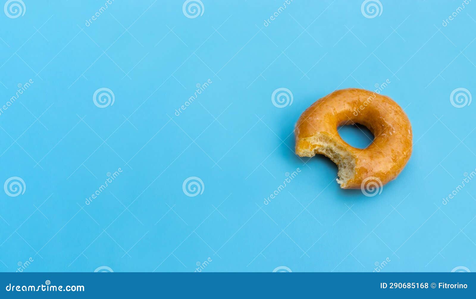 Bitten Glazed Donut Isolated on Blue Background Stock Photo - Image of ...